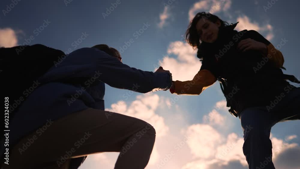 Helping hand in teamwork.Group of climbers daring climb to victory ...