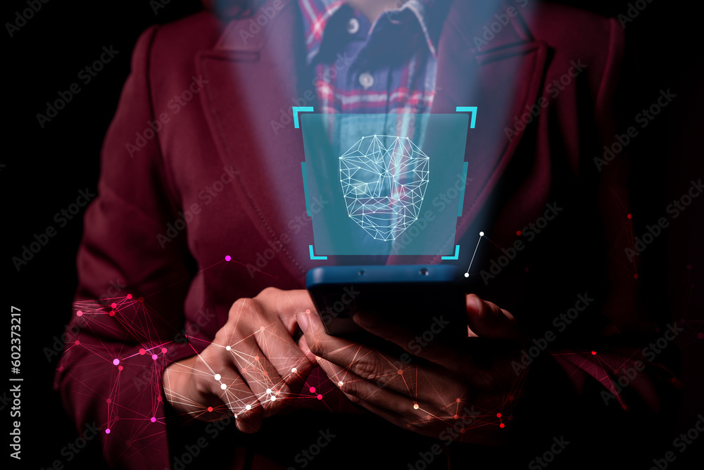 female hand holding phone Currently using a face scanning system to ...