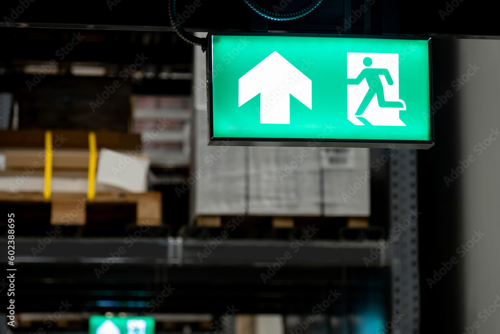 Emergency exit sign or fire exit sign hanging on rack structure in ...