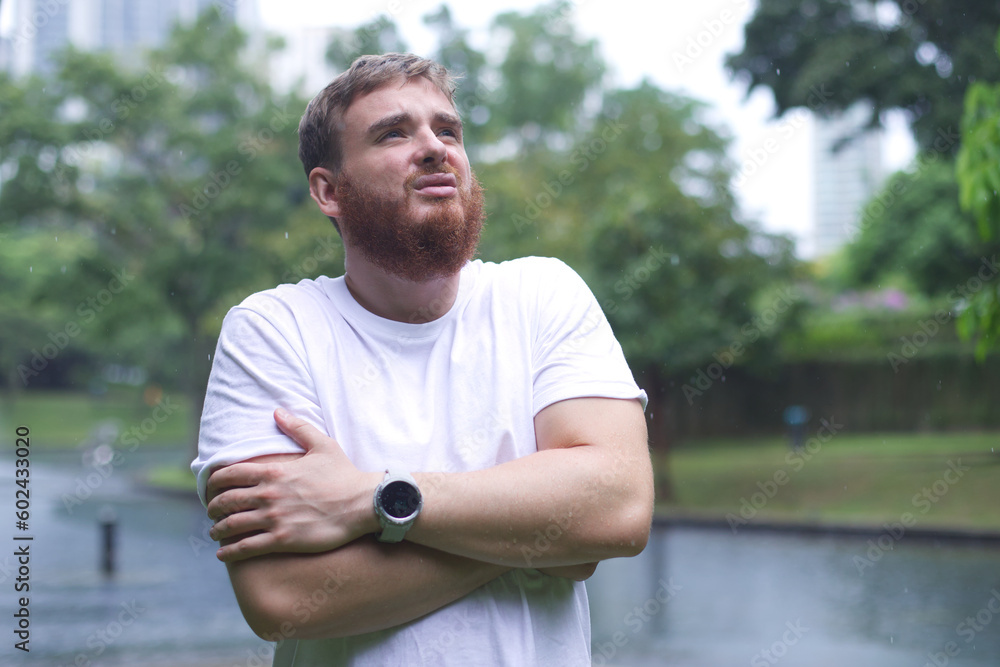 Sad frozen man under summer rain.emotional wet in the rain without ...