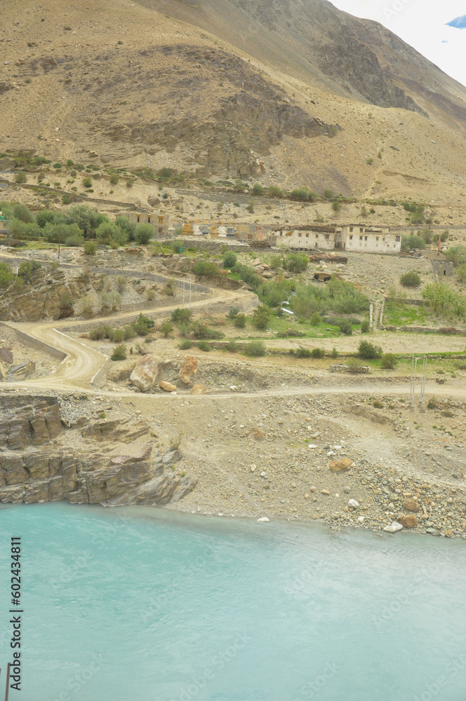 Beautiful view of Ladakhi traditional buildings with flowing Indus ...