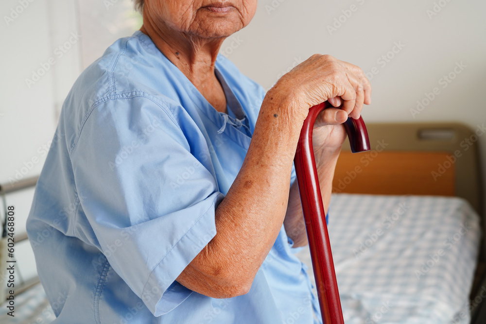 Asian elderly disability woman patient holding walking stick in ...
