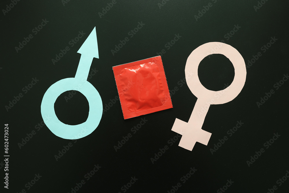 Male and Female symbols with condom on black background Stock Photo ...