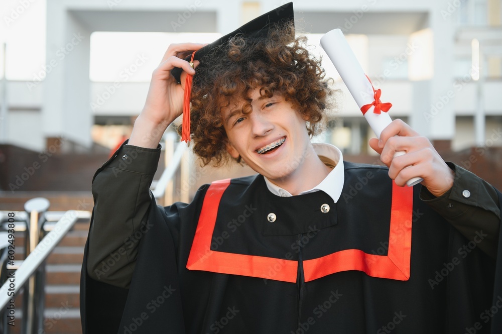 Graduation from university. Young smiling boy university graduate in ...