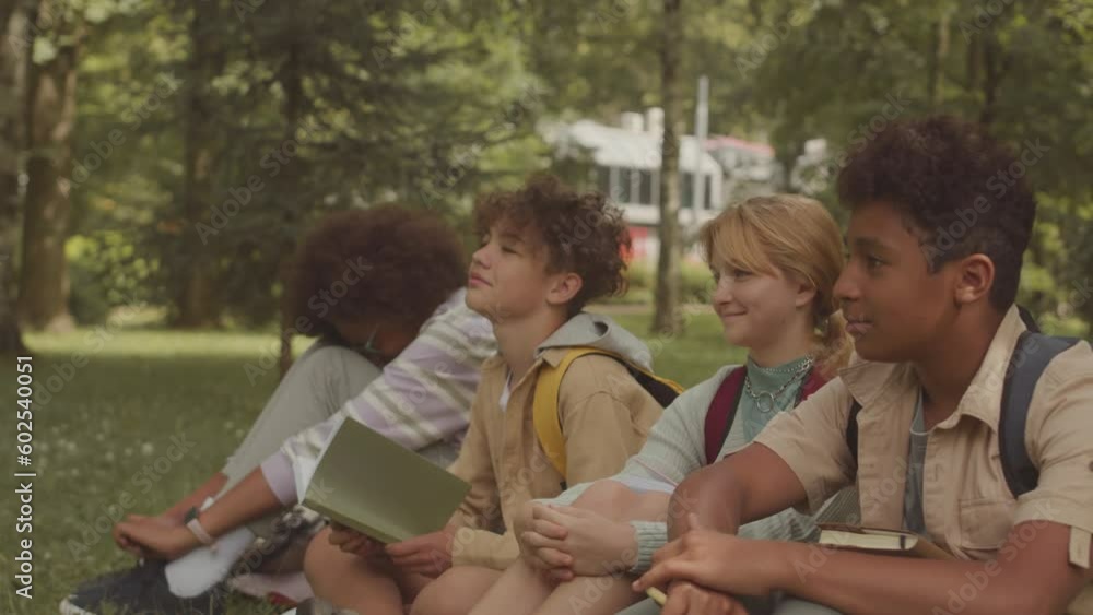 Small group of diverse preteen schoolkids raising their hands while ... Small group of diverse preteen schoolkids raising their hands while ...