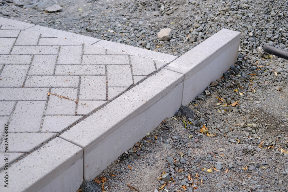 gray paving blocks on the ballast, side view, construction site of ...