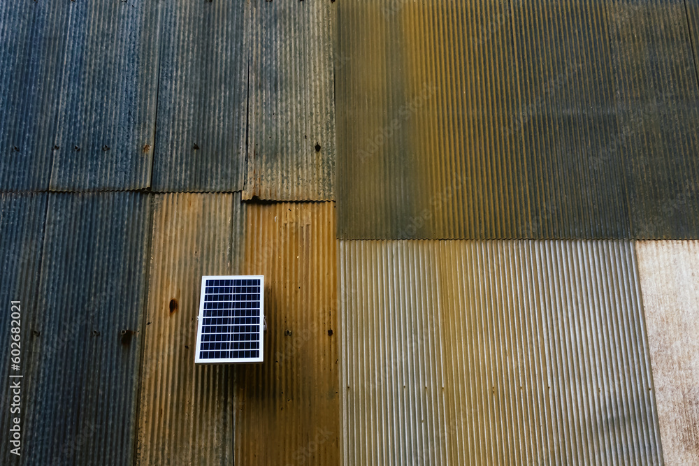 Solar panel attached on old zinc wall. Electric solar panel on the ...