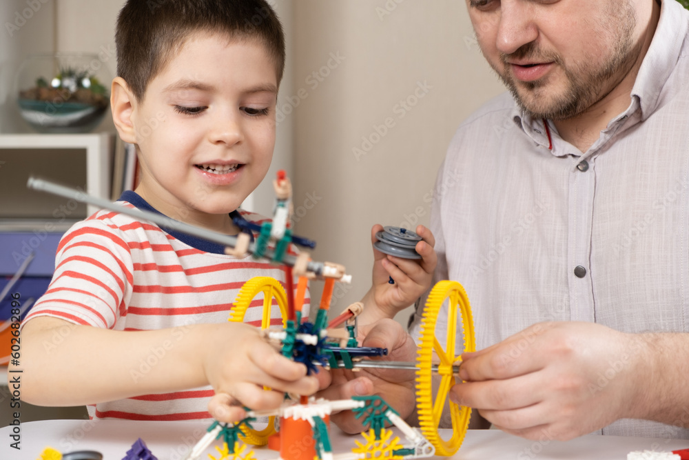 Dad and son build figures from the constructor. Spending time together ...