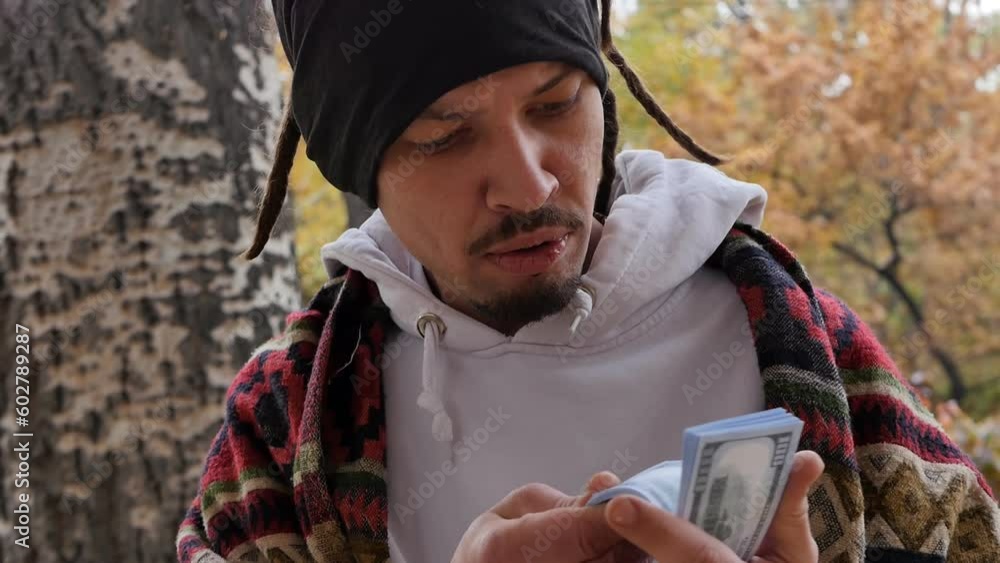 Portrait of a young Brazilian man with dreadlocks and a beard with a ...