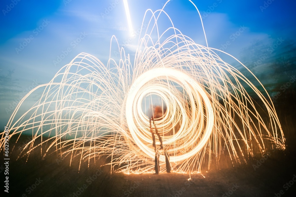 Firetrail of sparks flying throught the air to create a vortex worm ...