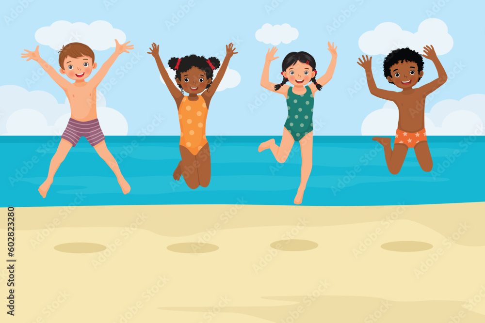 Cute kids in swimsuits jumping together on the beach having fun on ...