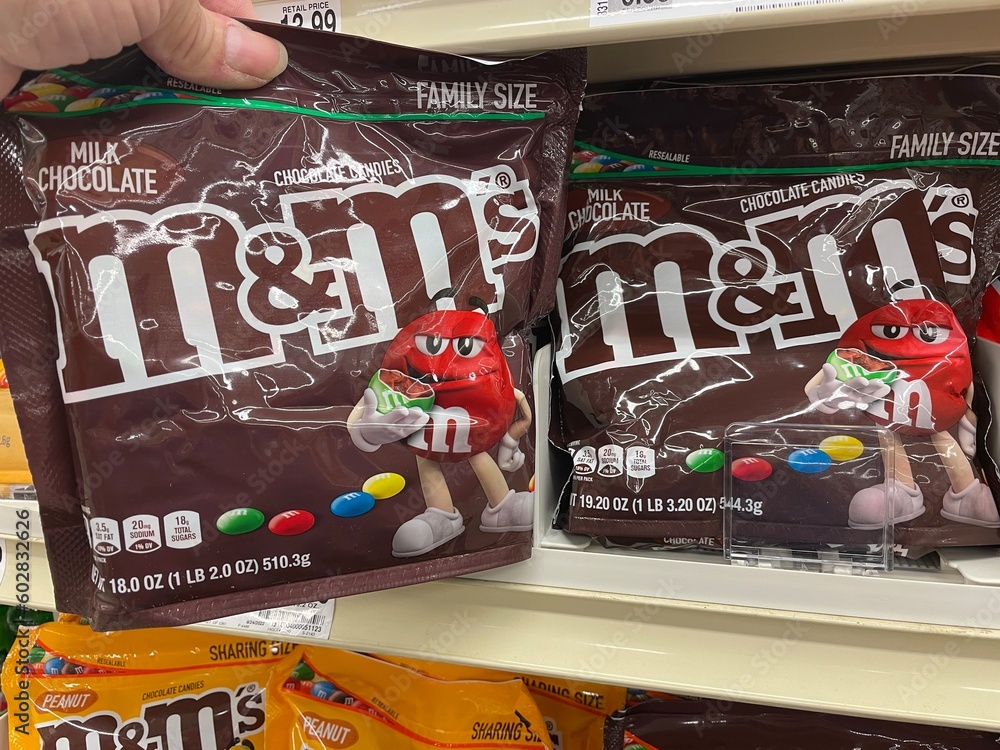 Grocery store hand selecting M&m's MMs Chocolate candy Stock Photo ...