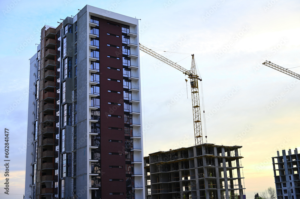 New high-rise buildings under construction in an urban setting. Cranes ...