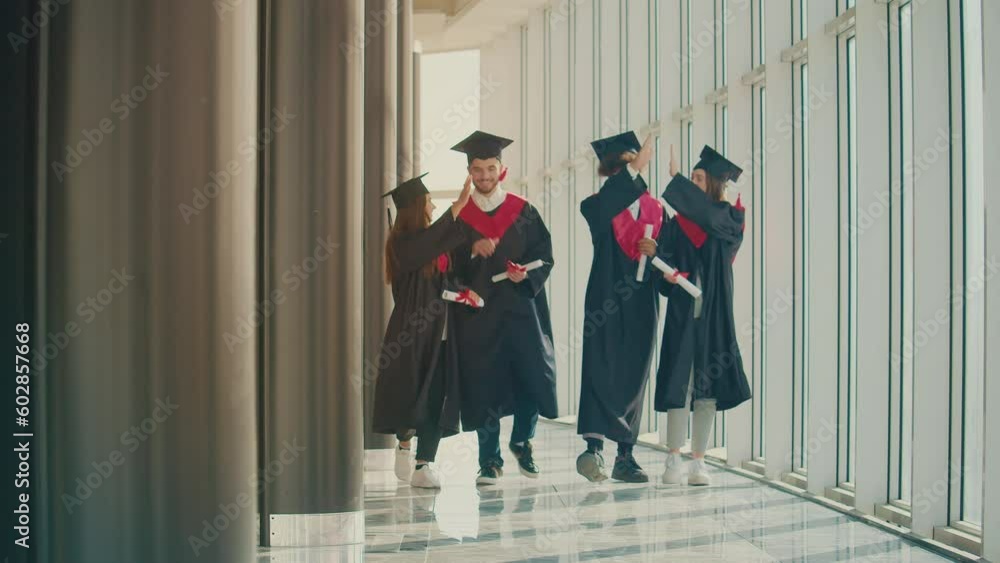 Happy and Successful Graduates in the Mantle and Cap Giving High Five ...