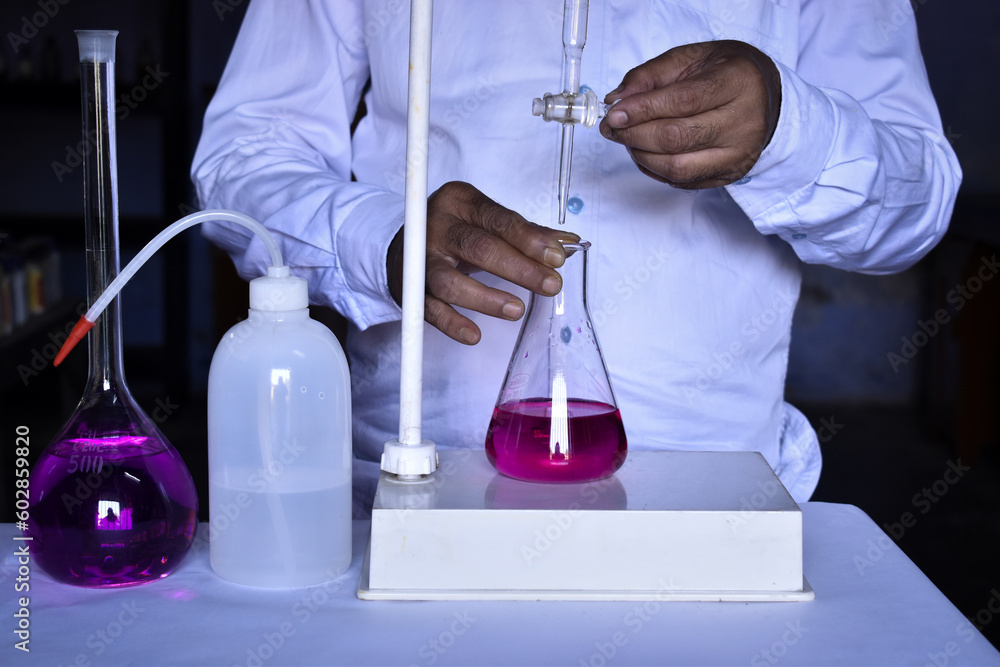 Photo & Art Print The chemist adds solutions with neutralization of ...