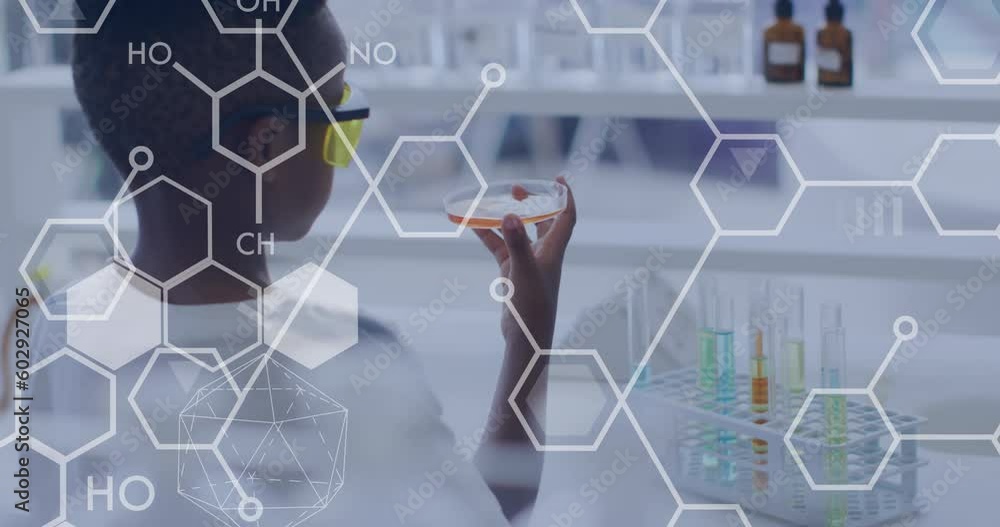 Animation of elemental diagrams over african american schoolboy holding ...