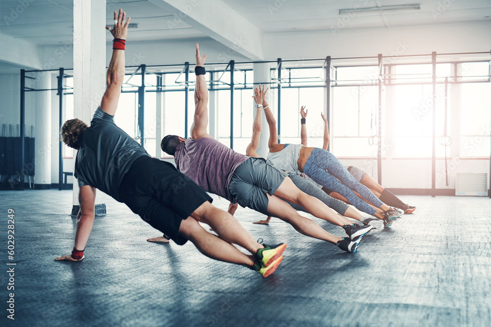 Fitness, group class and athletes doing a exercise in the gym for ...