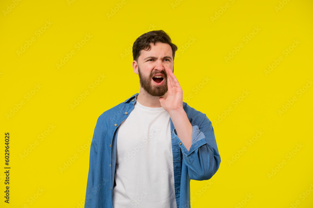Shouting young man with his mouth wide open. Male model in a blue shirt ...