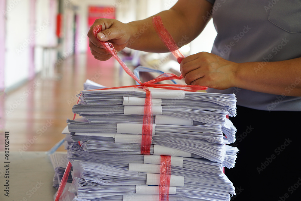 Closeup hands hold stack of used paper to recycle or combine to use ...