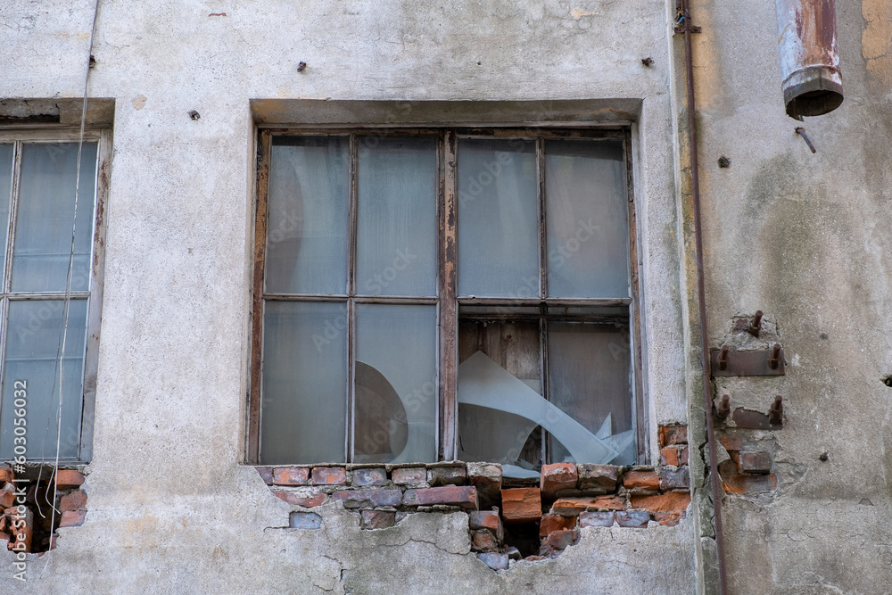Broken industrial window in a concrete wall with falling bricks Stock ...
