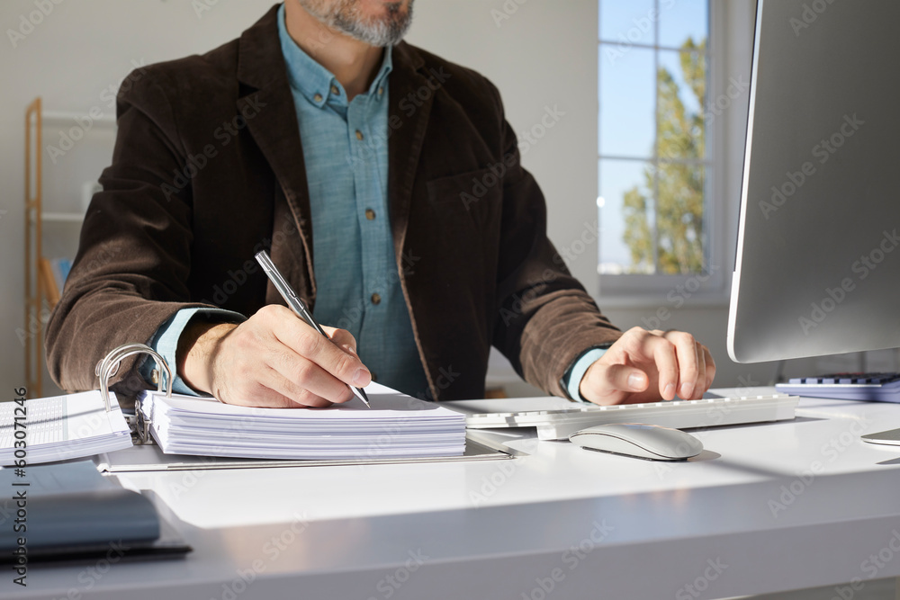 Mature accountant, bookkeeper, businessman or auditor working at office ...