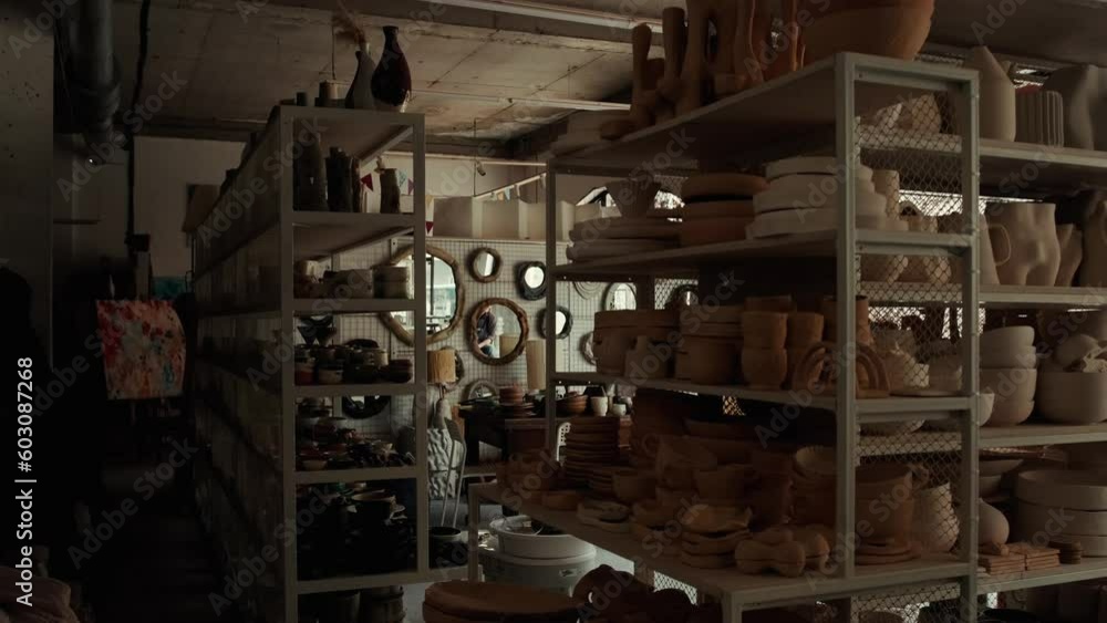 The space of the ceramic workshop. Racks with earthenware. White ...