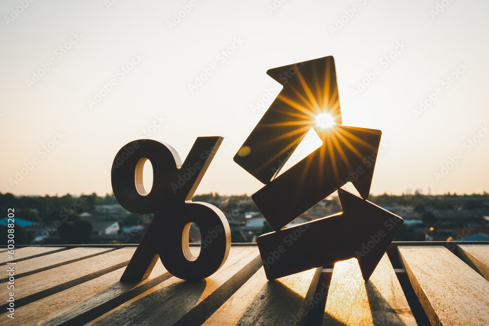 Silhouette of percentage model and up arrow with evening sky Key ...