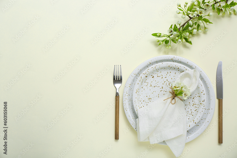 Beautiful table setting with blooming tree branches on light background ...