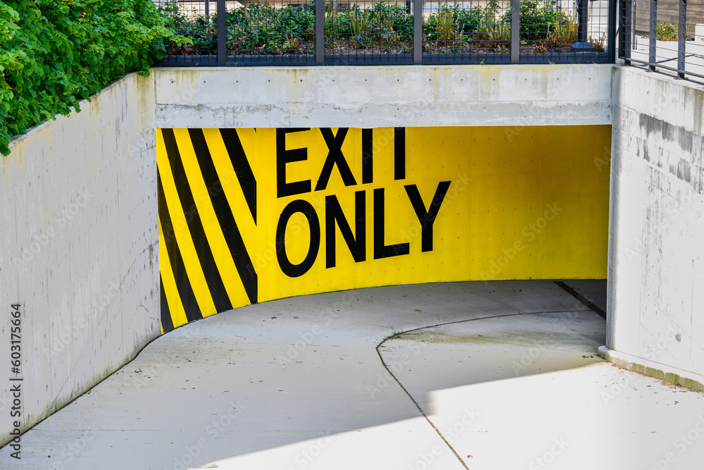 Exit only sign on entire wall of underground garage exit Stock Photo ...