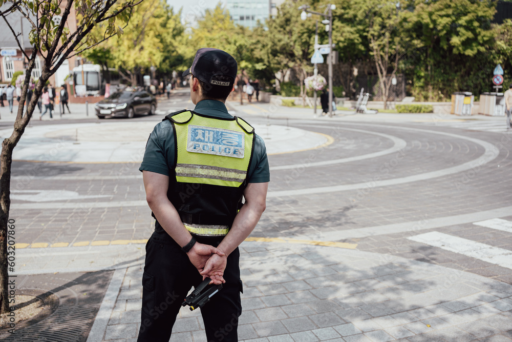 Korean police uniform standing holding radio communication in Seoul ...