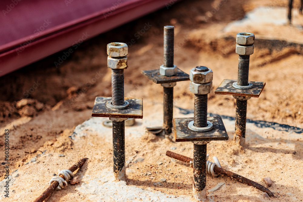 Close up the anchor bolts in concrete base of new edifice with ...