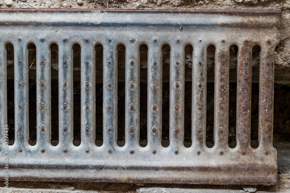 Detail of the metal grid for water drainage and waste drainage on the ...