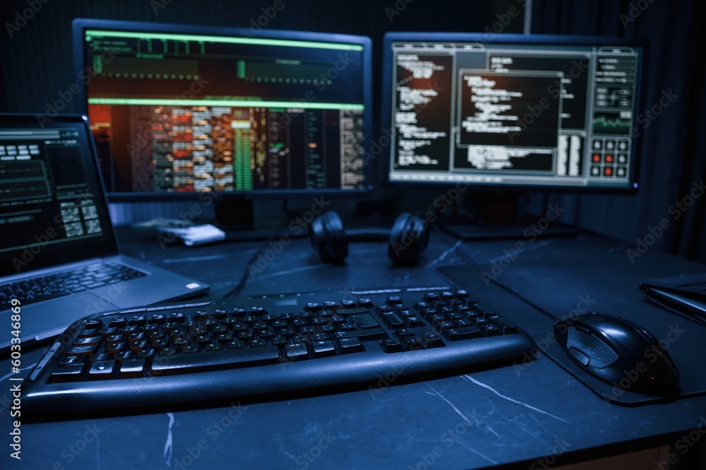Keyboard and screens. Cyber criminal haker dark room for massive attack ...
