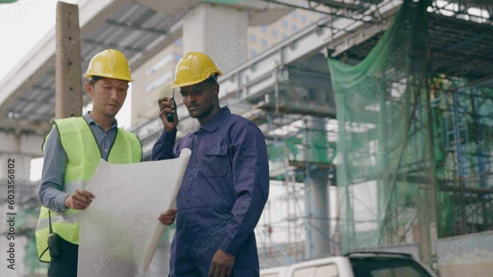 Structural engineers and construction workers are holding blueprints ...