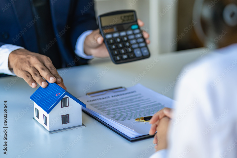 Businessman and Real Estate Broker Marketing planning and discussion at real estate brokerage ...