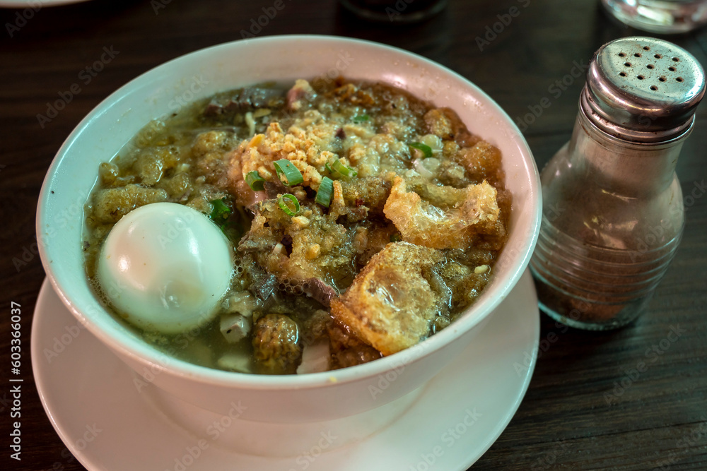 Batchoy, a Filipino noodle soup of pork offal, crushed pork cracklings ...