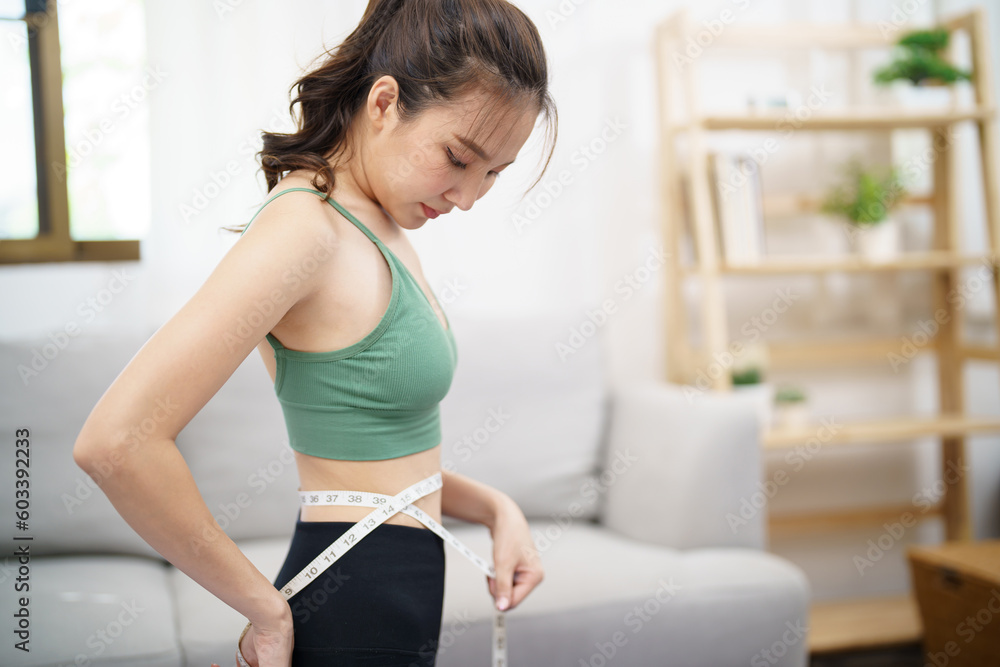 Asian woman with anorexia with measuring tape feeling unhappy. Anorexia ...