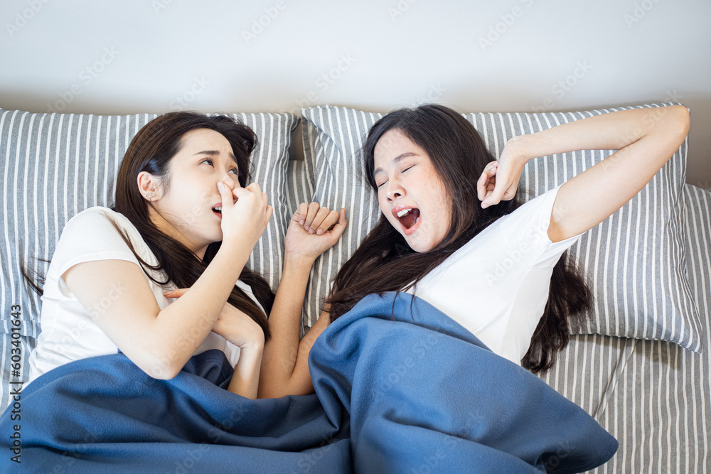 Upset Asian Gay Woman Covering Her Nose Because Of The Bad Breath Of