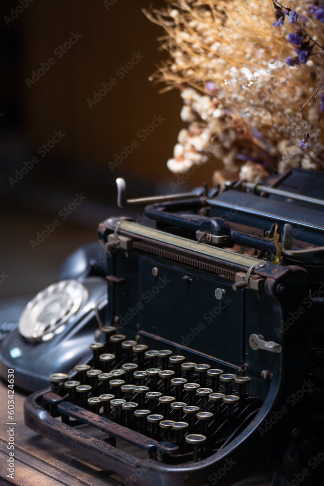 Vintage black phone, old typewriter on table.Typewriter and antique ...