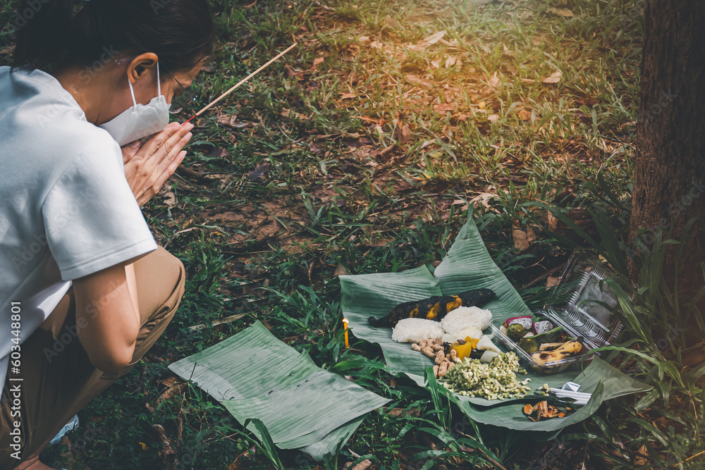 Asian women pay homage to sacred objects as part of Buddhist religious ...