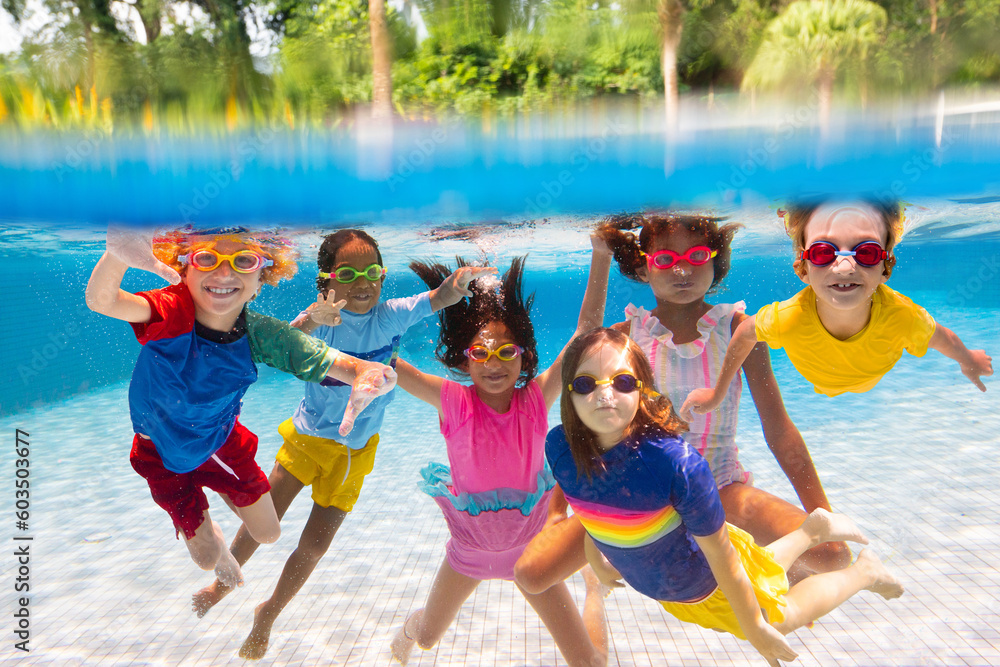 Kids jump into swimming pool. Summer water fun. Stock Photo | Adobe Stock