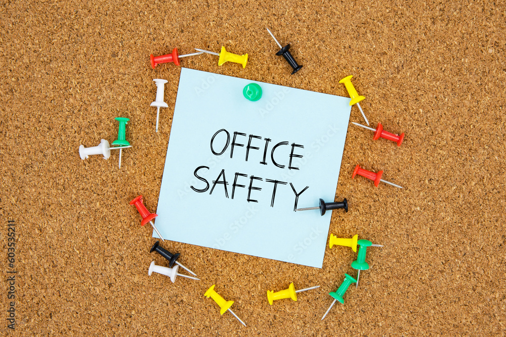 Office safety text on light blue post-it paper pinned on bulletin cork ...