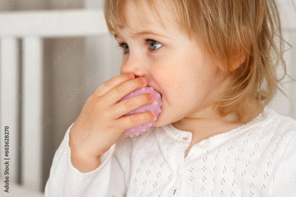 Cute baby girl playing tactile wooden and silicone toys. Young child ...