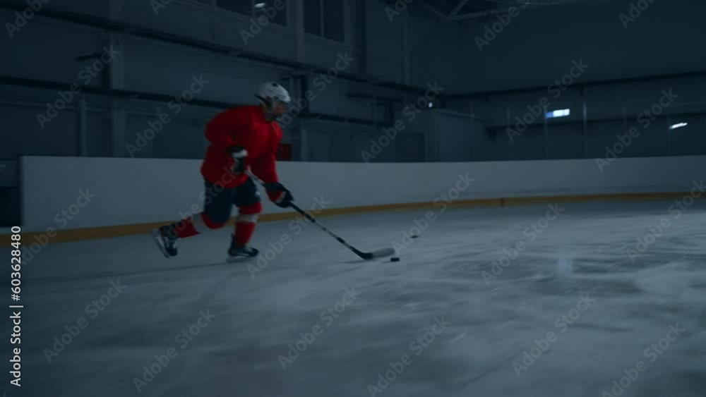 Dynamic ice hockey rink arena with a professional player shooting ...
