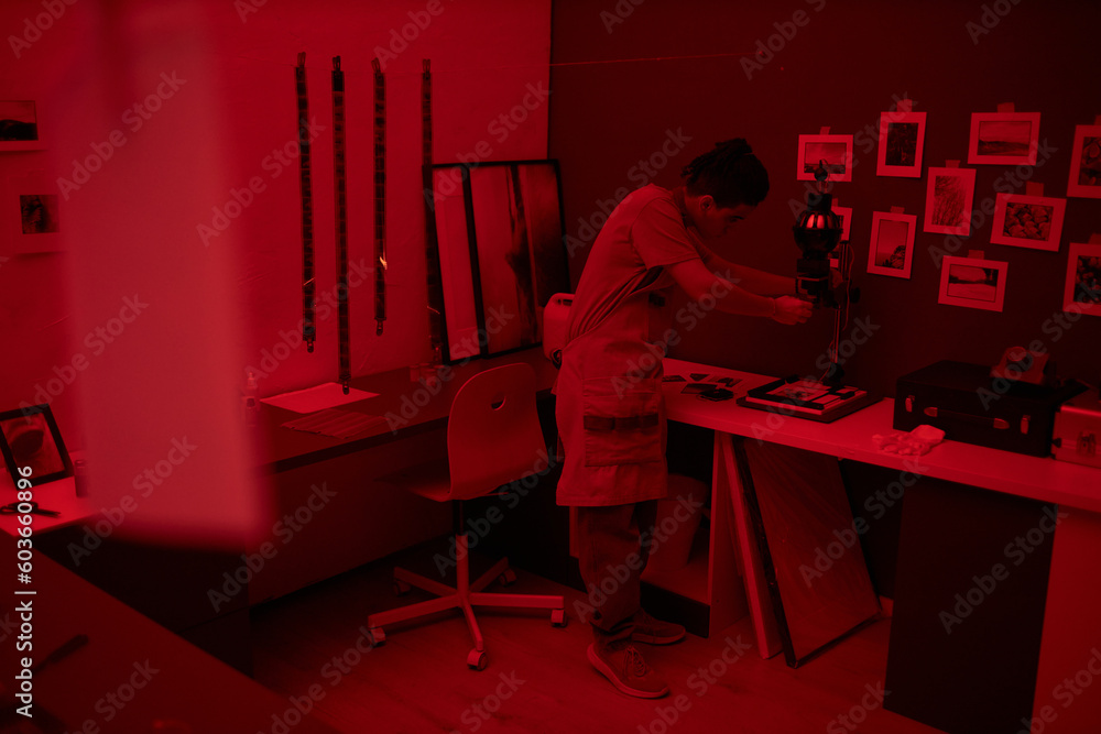 Professional photographer using special equipment to work with photos ...