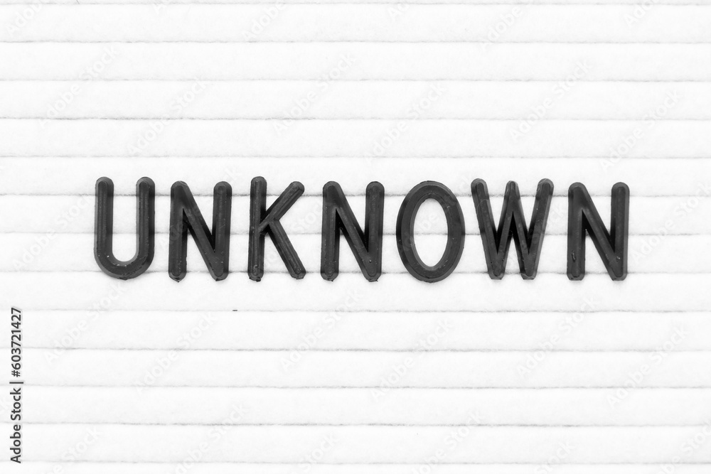 Black color letter in word unknown on white felt board background Stock ...