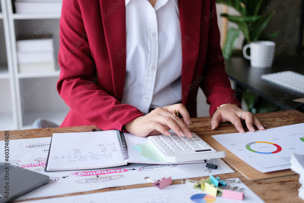 Deduction planning concept. Asian young woman hand using calculator to ...