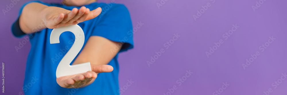 White number 2 in hand. The hand holding the number 2 symbolizes choice ...