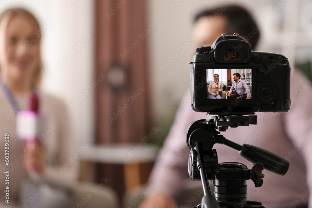 Female journalist with microphone having an interview with man on ...