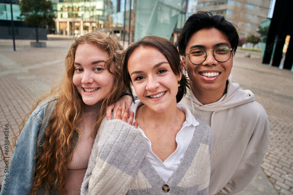 Portrait of three smiling multiracial young college students. Happy ...